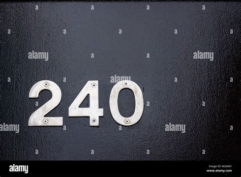 House Number With The In Metal Digits On A Wooden Front Door