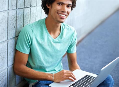 Online Learning Is So Convenient A Young Man Typing On His Laptop And Smiling At The Camera