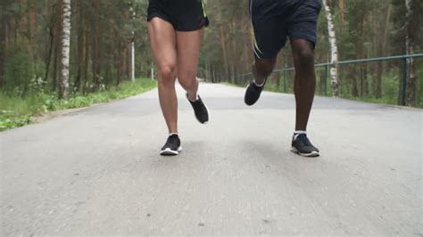 Free Stock Video Man And Fit Babe Woman Chatting And Running Along Forest Road In Morning