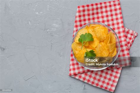 색깔이있는 배경에 냅킨이있는 그릇에 감자 칩 그릇에 맛있는 바삭한 감자 칩 텍스트를위한 공간 위쪽 보기 0명에 대한 스톡 사진