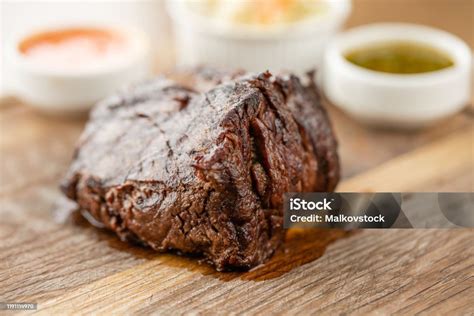 튀긴 건조 숙성 쇠고기 필레 Chateaubriand 메달리온 스테이크 절인 양배추와 두 소스와 자연 나무 판에 서빙 바비큐 레스토랑 메뉴 갈비 음식에 대한 스톡 사진 및