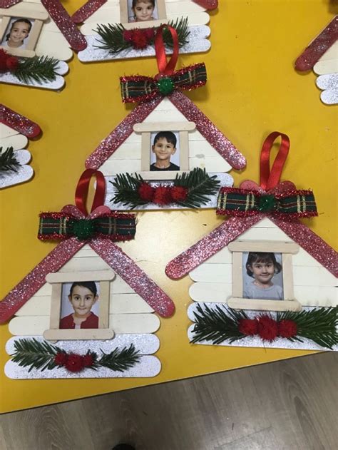 Christmas Decorations Made To Look Like Houses With Pictures On Them And Ribbons Hanging From