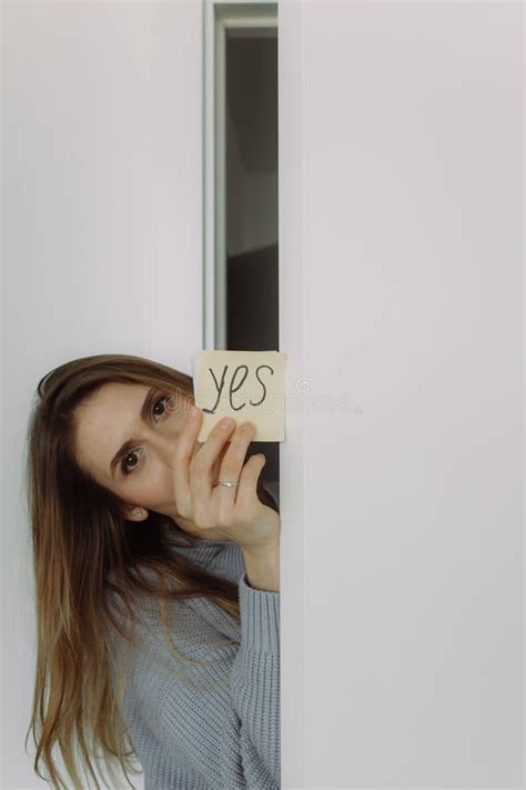 Young Beautiful Blonde Woman With A Sign Yes And No Choice And The Choice Yes Or No Stock Image