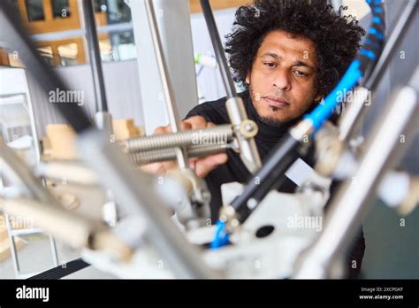 Focused Engineer Working On Programming A Robotic Gripper Arm