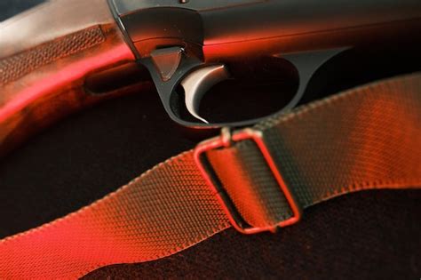 Premium Photo Trigger Of A Rifle On Black Background With Red Lightning