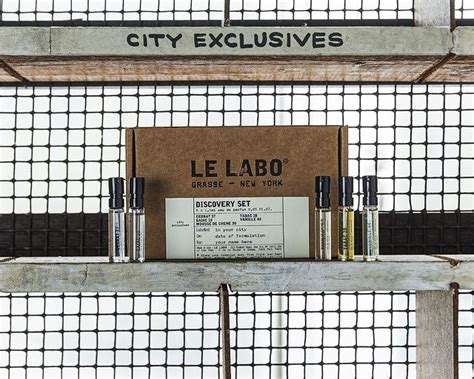 the label for le labo is displayed in front of a wire mesh wall and door