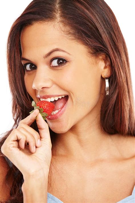 Mmmm Fruity Freshness A Beautiful Young Ethnic Woman Taking A Bite Of A Fresh Strawberry