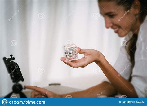 Vlog Girl Sitting In Her Room And Reviews Cosmetic Products Online Via
