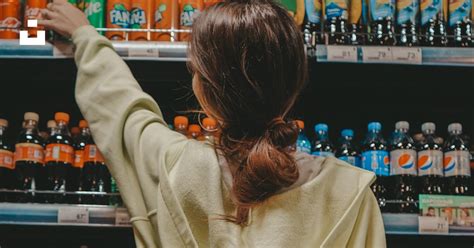 베이지색 스웨터와 파란색 데님 청바지를 입은 여자가 유리병 앞에 서 있다 사진 Unsplash의 무료 사람의 이미지