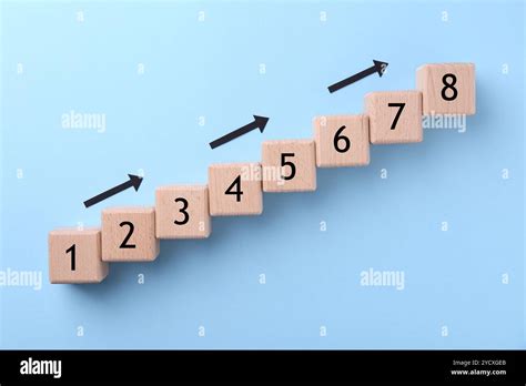 Wooden Numbered Cubes And Arrows On Light Blue Background Top View Step By Step Concept Stock