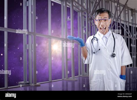 Asian Nerd Scientist With A Stethoscope Standing And Showing Something On The Building With A