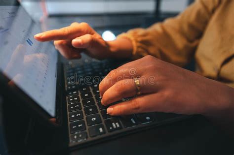 Closeup Of A Female Hand Operating A Touch Screen Laptop In A Business