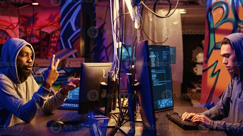Experienced Hackers Writing Lines Of Code In Computers From Their Underground Bunker Discussing