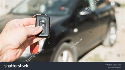 Hand Pushing Remote Control Button Unlock Stock Photo 2182184801
