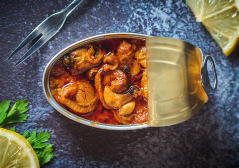 Premium Photo Canned Scallops With Sauce Open On A Dark Blue Table