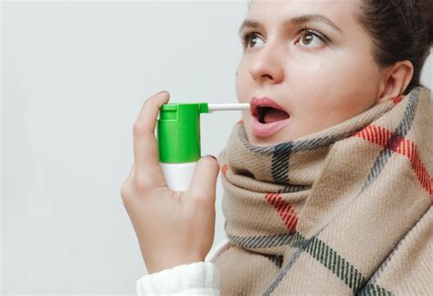 Premium Photo Young Girl Wrapped In A Scarf Squirting Her Throat With