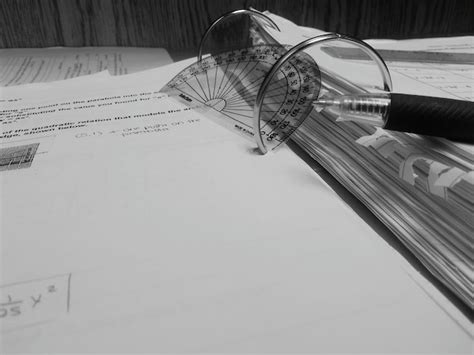 Premium Photo Protractor And Pen On Open Book