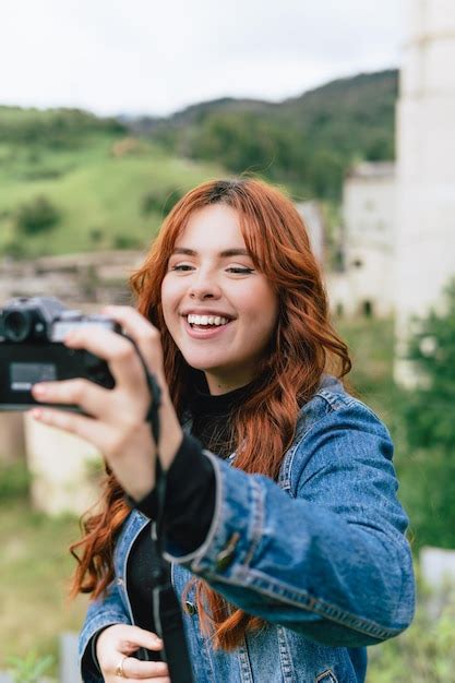 A Young Girl Taking Pictures With A Small Professional Camera Premium