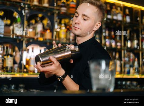 Close Up Of Bartender In Black Clothes Mixing Ingredients Of Alcoholic
