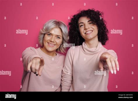 Image Of Happy Two Women Friends Having Fun Isolated Over Pink