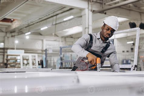 Factory Worker Assembling Aluminum Window Frames Using Pneumatic