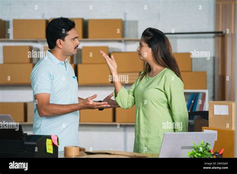 Two Business Partners Or Coworkers Arguing Each Other At Warehouse Or