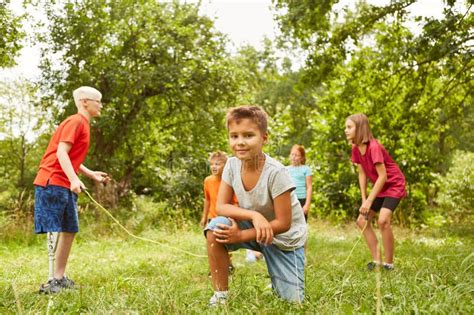 Smiling Girl Kneeling On Grass At Park Stock Image Image Of Happiness Greenery 300566401