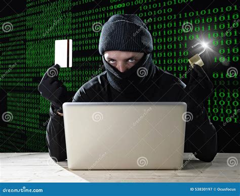 Man In Black Holding Credit Card And Lock Using Computer Laptop For Criminal Activity Hacking
