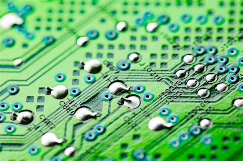 Premium Photo Electronic Green Printed Circuit Board With Soldered Copper Contacts Holes