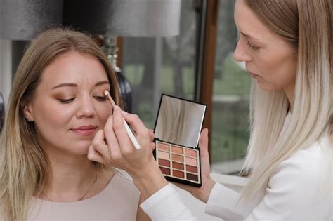 Premium Photo Makeup Artist Applying Decorative Makeup In Beauty