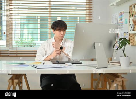 Handsome Asian Male Website Developer Working On Mobile Application
