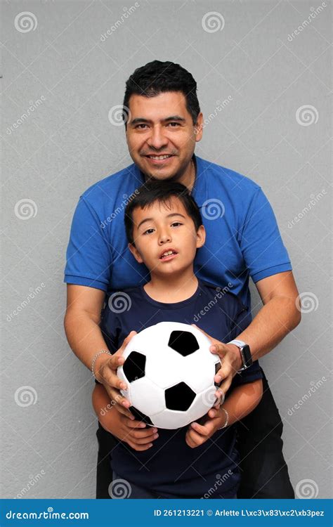 Hispanic Dad And Son Share Their Love For Soccer They Take A Ball With