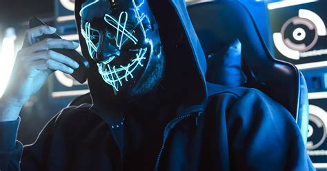 A Hacker Wearing A Mask To Cover His Face Is Using Computer To Hack
