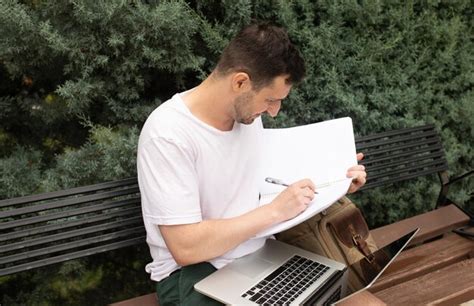 Premium Photo Man Writing On A Notepad In Park Male Babe