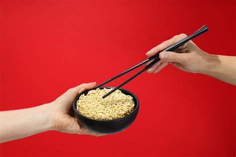 Premium Photo Instant Noodles In A Plate On A Red Background