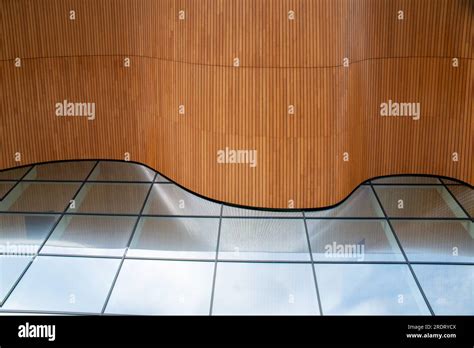 Part Of A Modern Building With High Glass Window And Floating Wooden