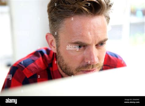 Close Up Portrait Of Handsome Man Working Behind Computer Screen Stock Photo Alamy