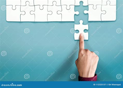 Complete Concept Hand Replace A Final Jigsaw Puzzle Piece Into Stock