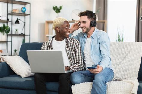 Premium Photo Multiracial Same Sex Couple Using Gadgets At Home
