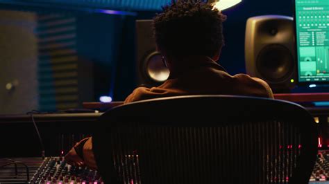 Team Of Artist And Technician Editing Audio After Recording Session In
