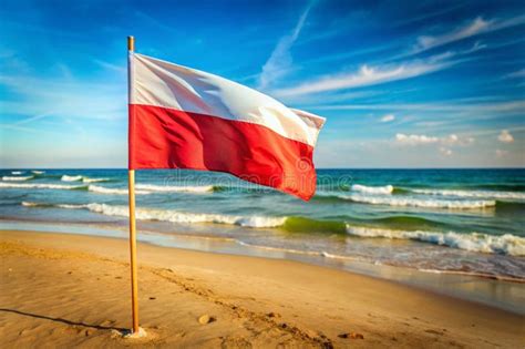 Polish Flag Waving On A Sandy Beach With Ocean Waves And Blue Sky