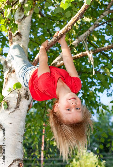 Happy Girl Hanging From A Tree In A Summer Garden Stock Photo Adobe Stock