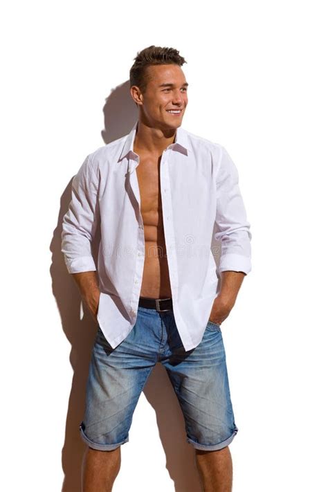 A Handsome Guy With Unbuttoned Shirt And Sunglasses Posing Over White Background Showing His