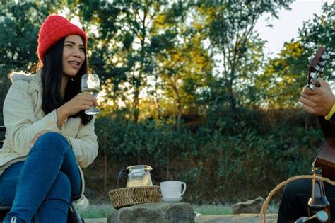 Premium Photo Woman Having Drink While Camping