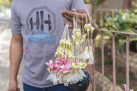 Baguio City Philippines A Sidewalk Vendor Peddling Sampaguita Garlands Near A Church Editorial