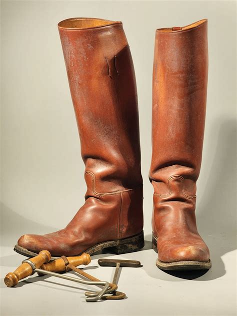 pair of vintage biltrite leather riding boots and three bootstrap hooks