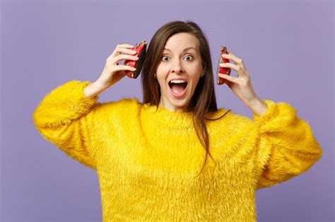 활짝 열려 입을 벌리고 젊은 여 자가 피타 하 야의 Halfs를 들고 보라색 파스텔 배경에 고립 귀 근처에 용 과일 사람들은 생생한 라이프 스타일 휴식 휴가 개념입니다 복사