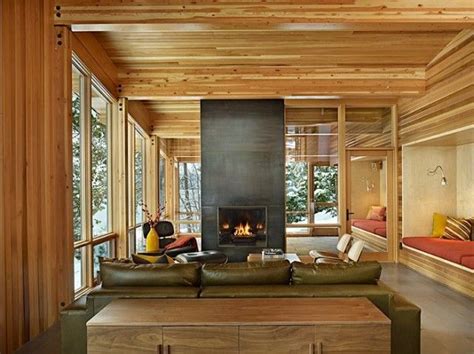 Cozy Fireplace And Large Windows Facing The Forest Full Of Snow This