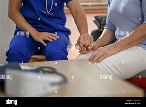 Cropped Image Of A Kind Doctor Holding Or Touching A Patients Hand To
