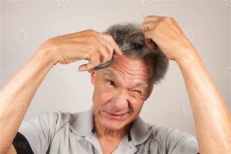 Mature Man Trying To Cut His Own Hair With A Pair Of Scissors 12000004